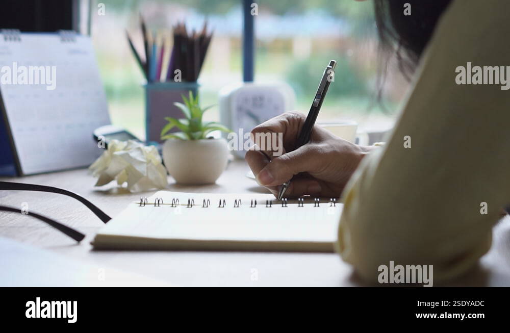 Working from home concept. Hand of Planner write timetable and daily ...