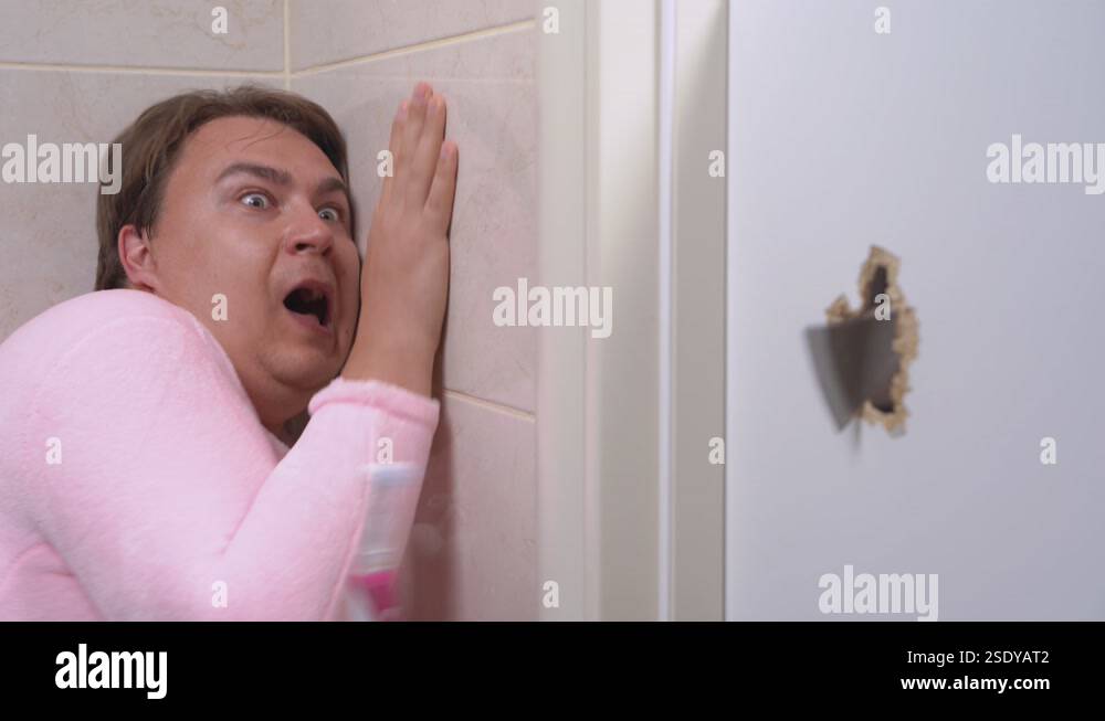 Scared man with toothbrush hides in bathroom from evildoer Stock Video ...