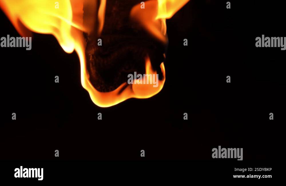Abstract background of a ball of flames falling through darkness Stock ...