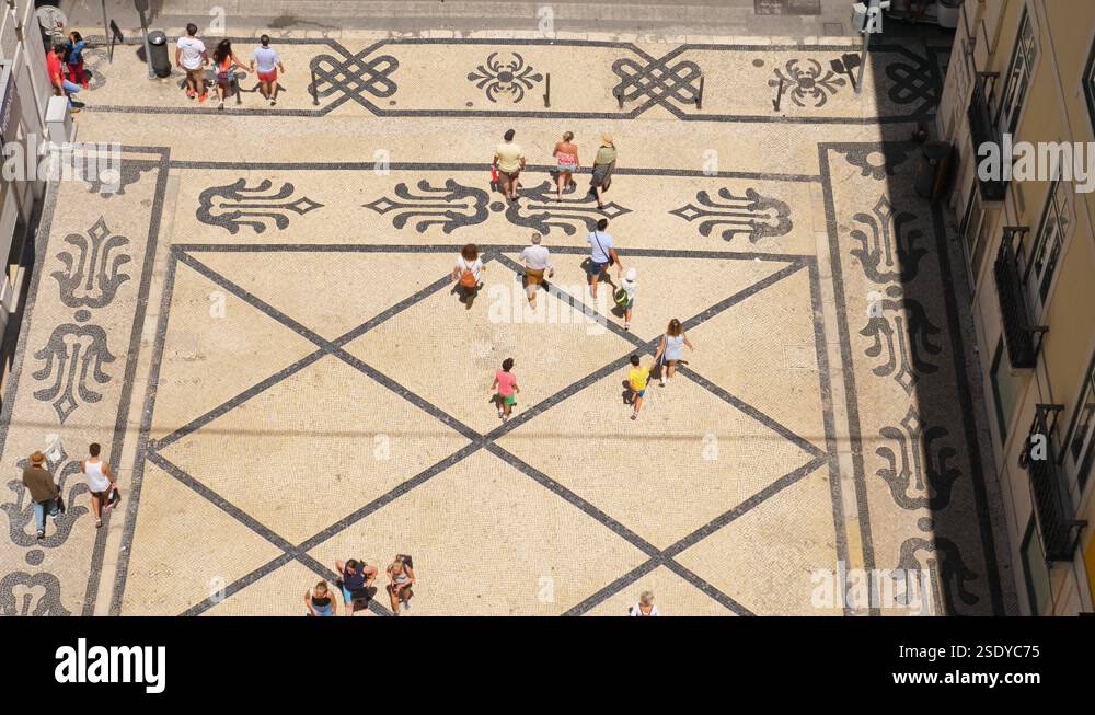 People walk at pedestrianized Rua Augusta street at Baixa downtown ...