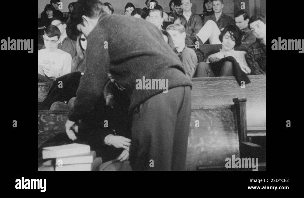 1960s: Students enter college classroom and sit. Books fall from sky ...