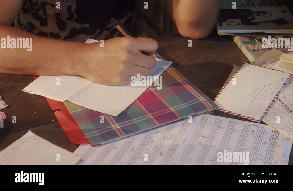 A man writing a letter with on sunset his pen on a piece of paper Stock ...