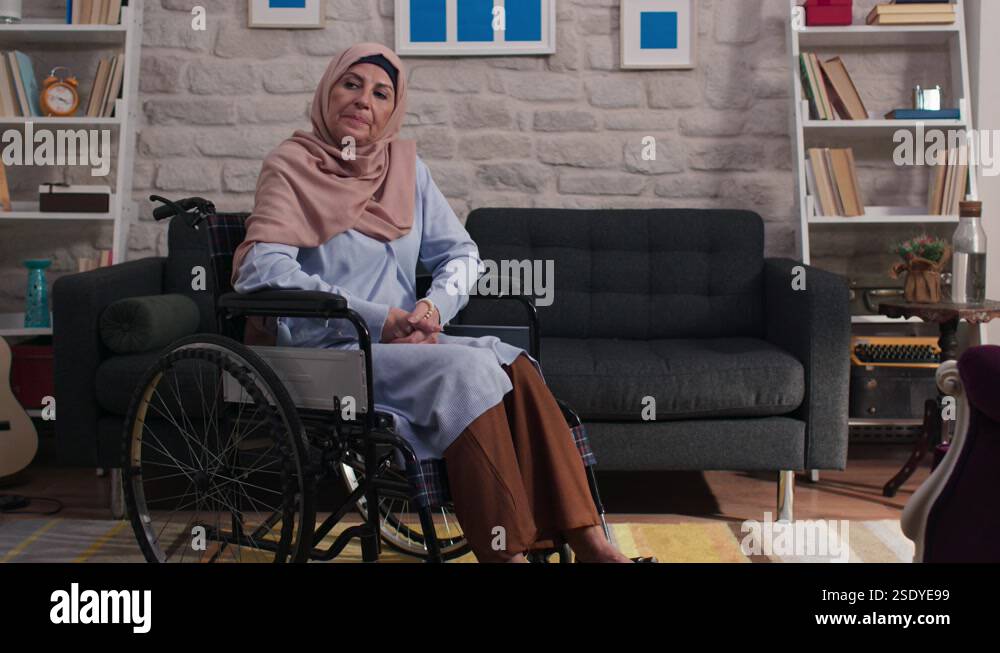 Sad disabled elderly woman with turban in a wheelchair alone in the ...