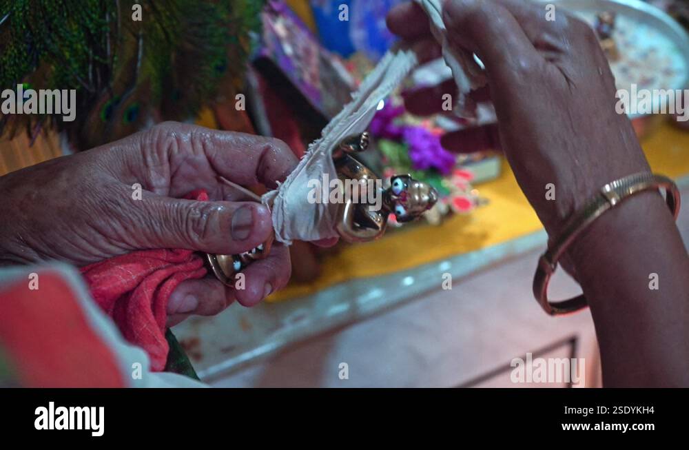 Female's Hands Wrapping Figurine Of Lord Krishna During Janmashtami ...