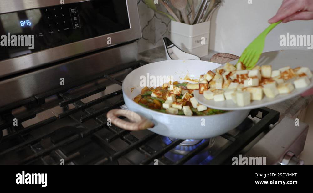 Woman Adding Cooked Paneer Into Frying Pan Of Hot Vegetables In 4K ...