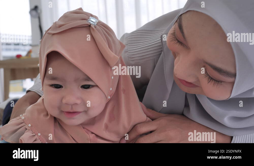 Close up of mother and little baby girl aged 6 months Play together on ...