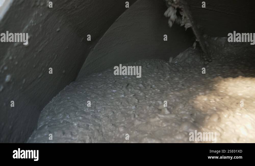 Concrete mixer rotating with cement, sand and water to prepare good ...