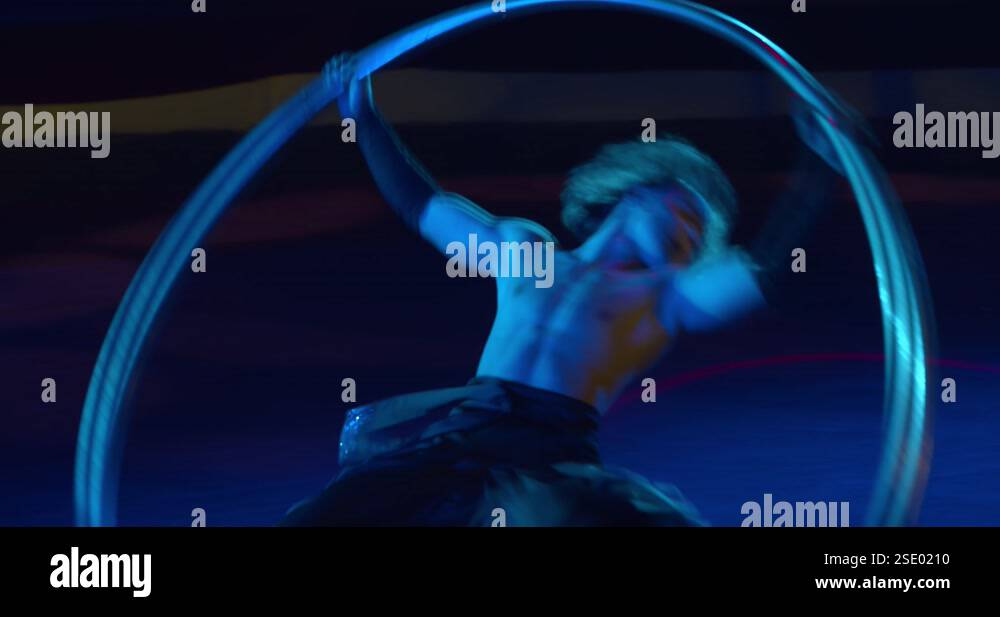 Difficult tricks performed by a young wheel gymnast on stage of a ...