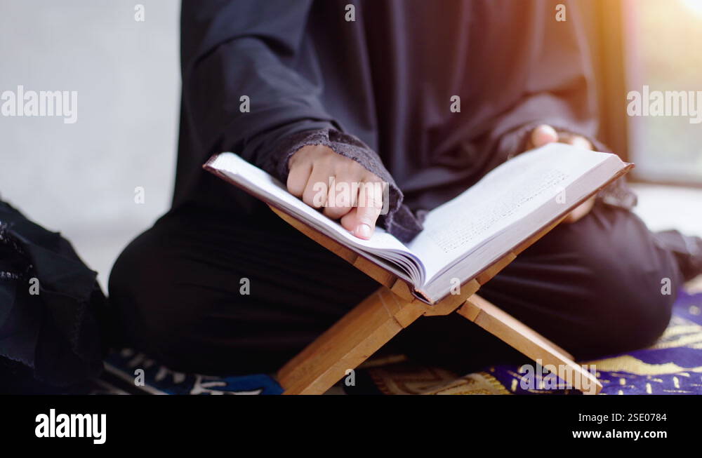 Portrait of an Asian muslim women in a daily prayer at home reciting ...