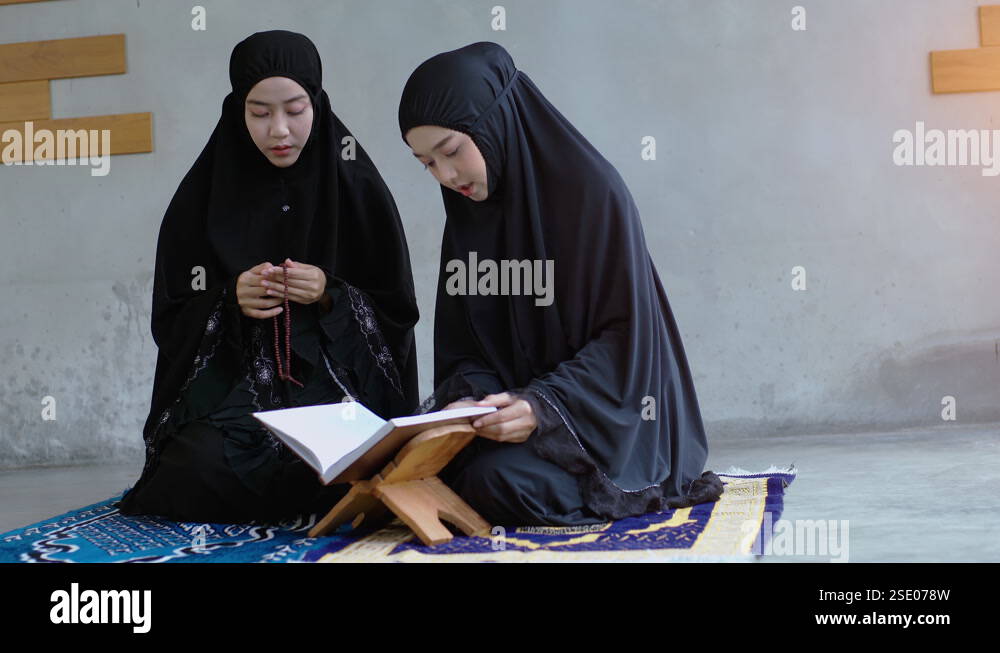 Portrait of an Asian muslim women in a daily prayer at home reciting ...