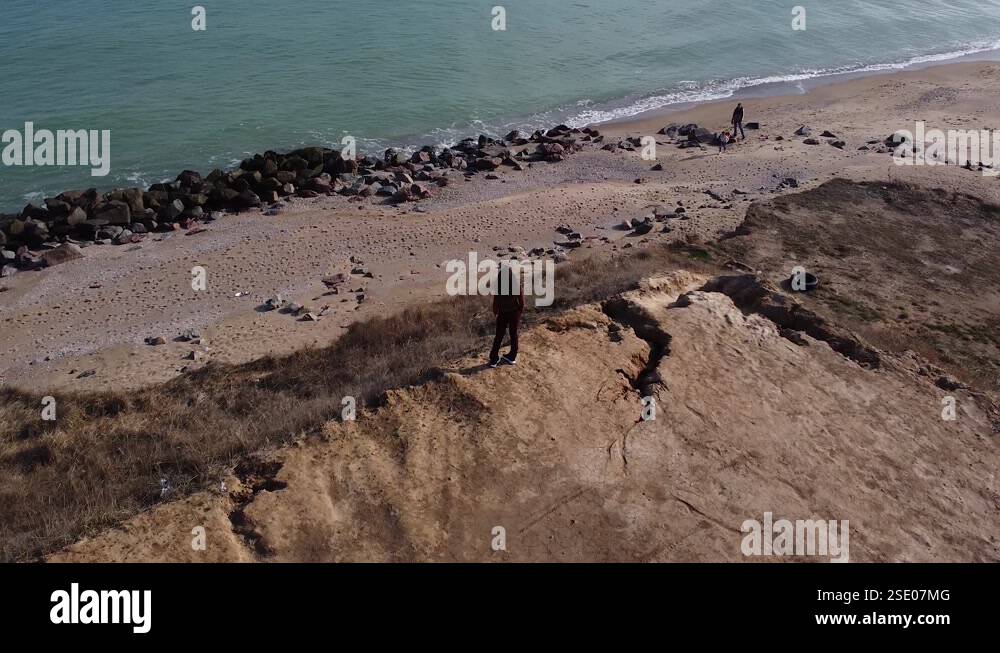 Beautiful aerial view of a drone, a happy woman dancing on the edge of ...