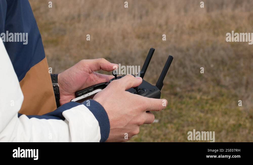 Remote drone in the male hands of a pilot close-up. Flying drone with ...