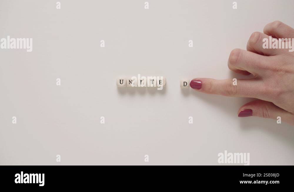 Index Finger Of Woman Pushed Letter D Dice To Complete The Word UNITED ...