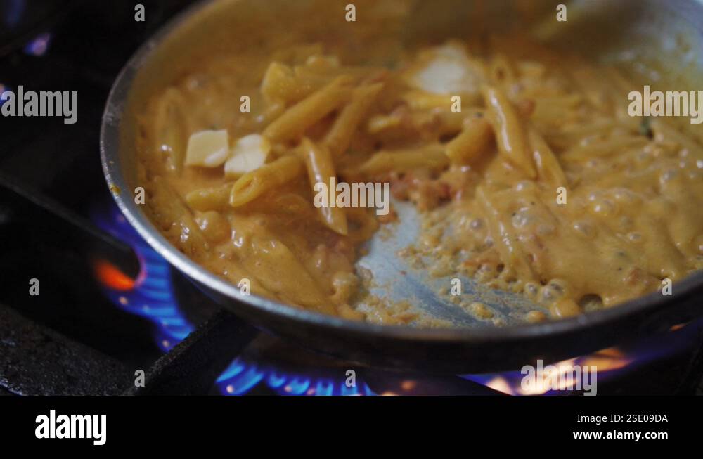 Cheese Melting On Pasta With Sauce While Chef Tossing And Stirring On ...