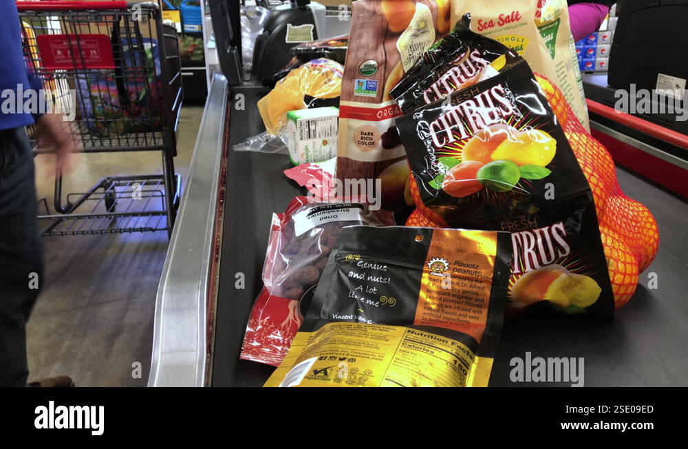 Many food items and packages on grocery belt at supermarket Stock Video ...