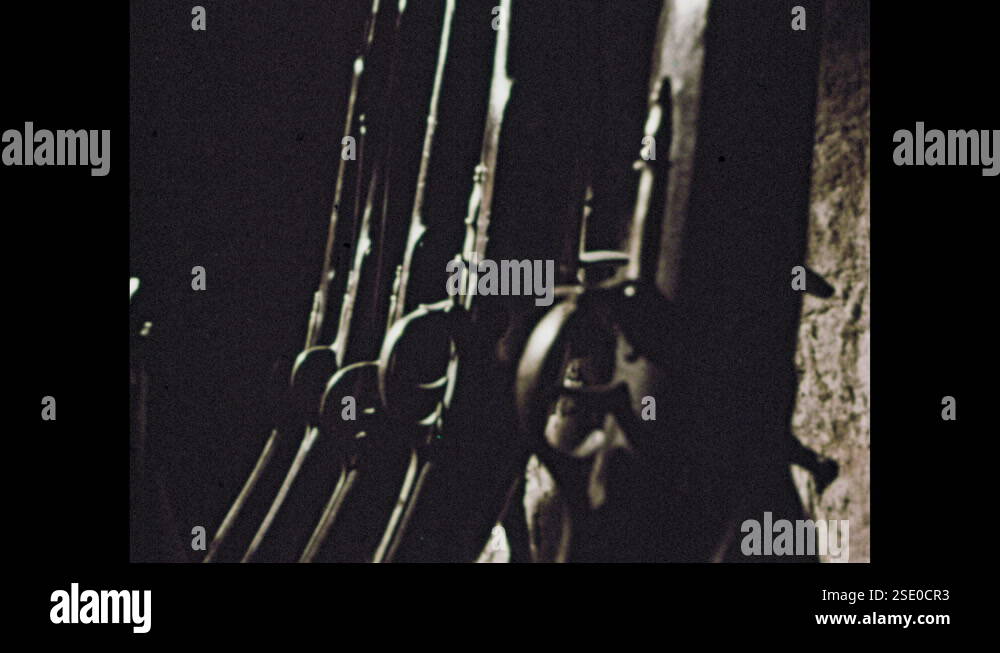 1950s: Rifles and leaned against wall in line. Rooftop of building ...