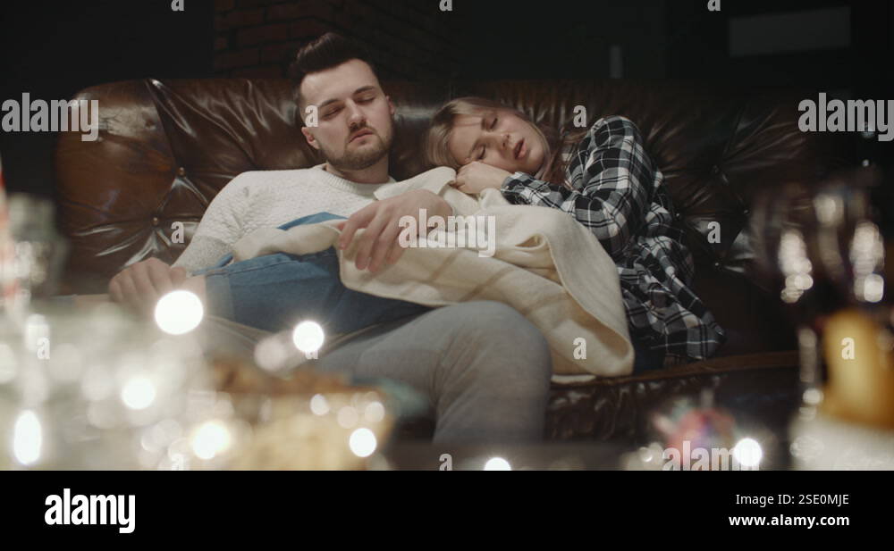 Young man woman fall asleep watching tv. Sleepy male female after ...