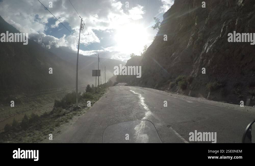 Travelling on the side of a mountain in bright sunshine in the ...