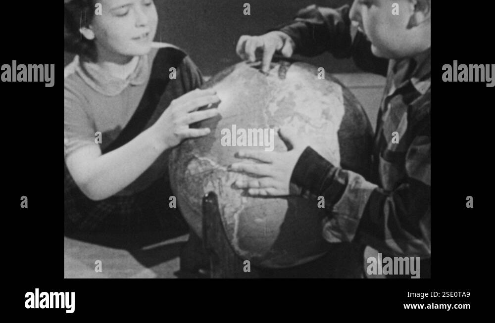 1950s: Globe of Earth. Two kids look over globe of Earth Stock Video ...