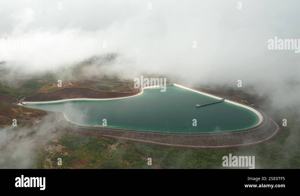 Aerial of Barragem do Pico da Urze in mist, water reserve of Madeira ...