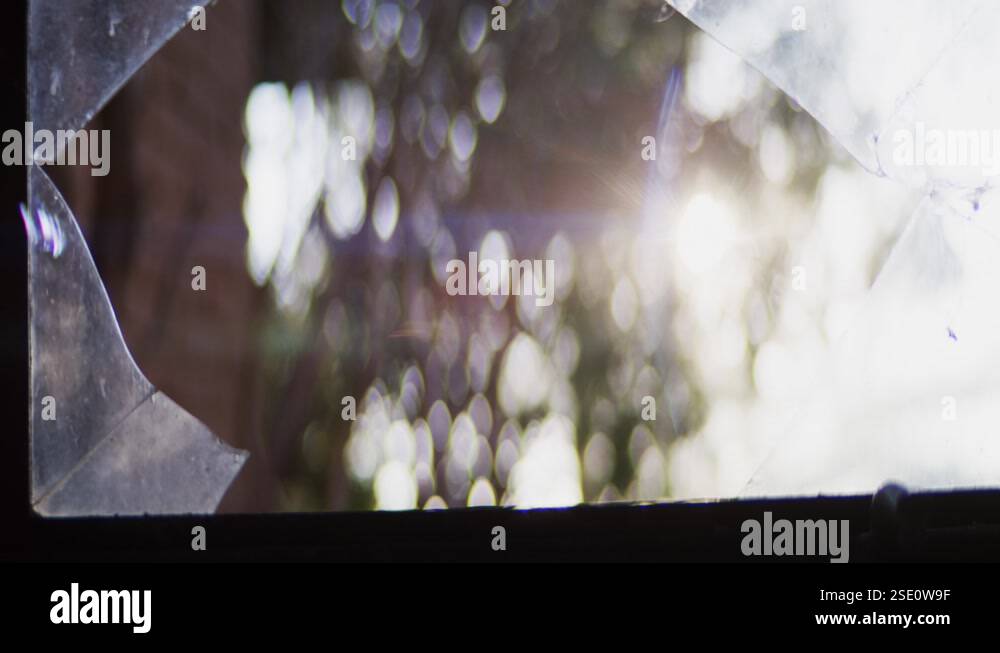 Light Shining Through a Sharp Broken Glass Window Stock Video Footage ...