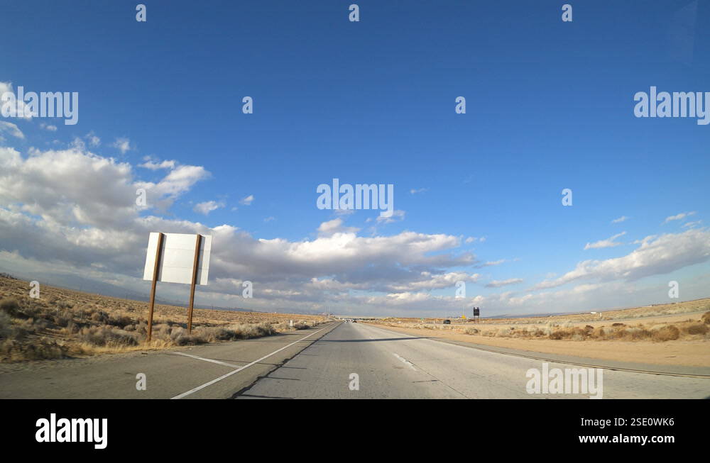 A view from the rear window of a vehicle traveling down a southern ...