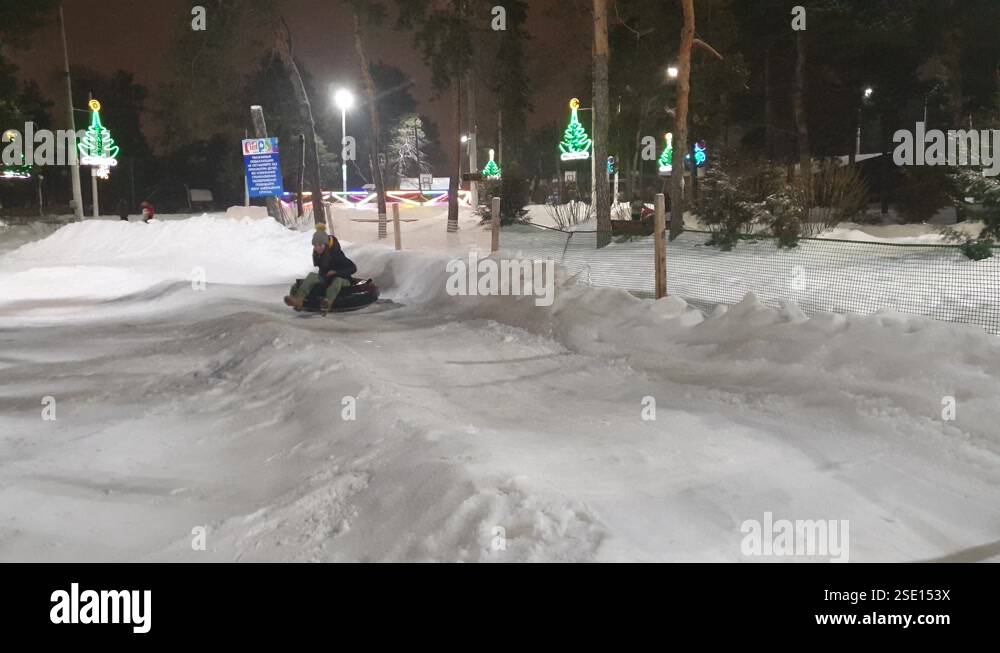 girl rides a tube from a high roller coaster in winter Stock Video ...