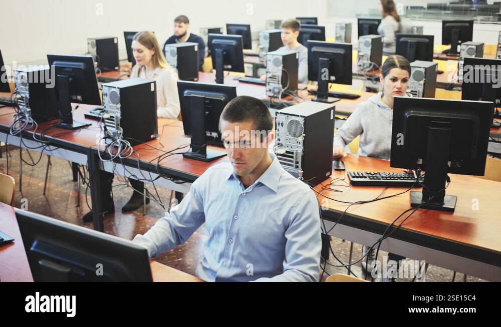 Group of people of different ages learning to use computers in ...