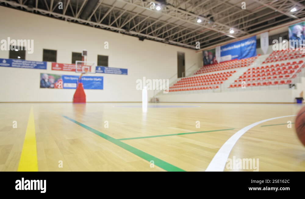 Slider Wide shot of Rolling Ball on the Wooden Floor of Basketball ...