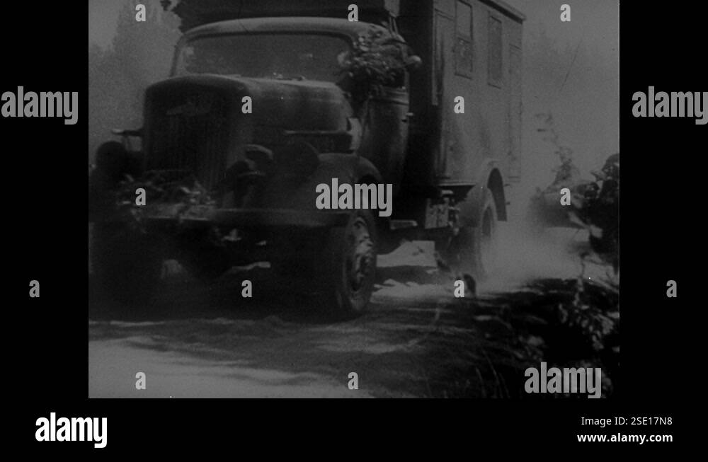 1940s: Nazi soldiers drive tanks and motorcycles down dirt road ...