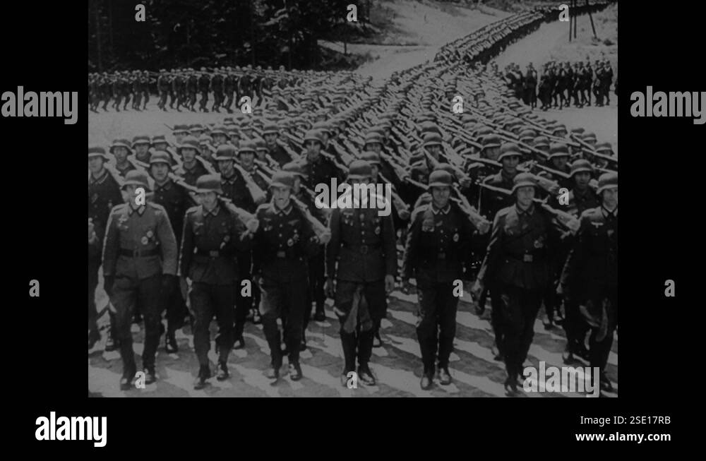 1940s: Rows of marching soldiers converge into one line. Map. Mountains ...
