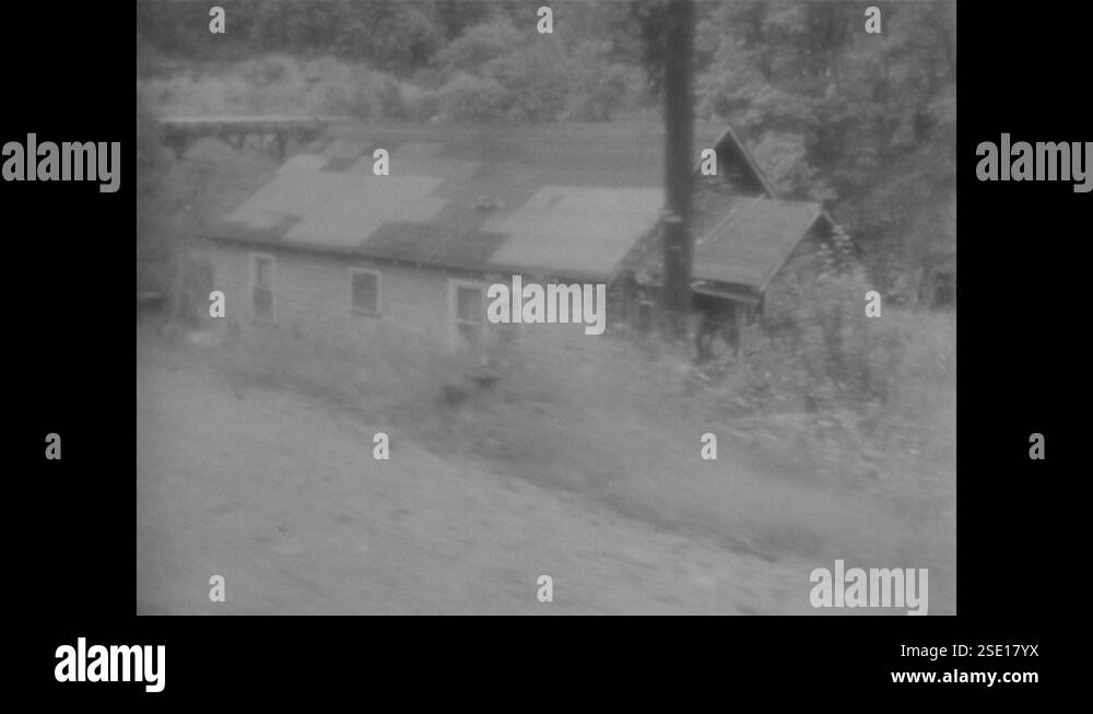 1960s: View of old farmhouse. Shack at side of road. Laundry hands from ...