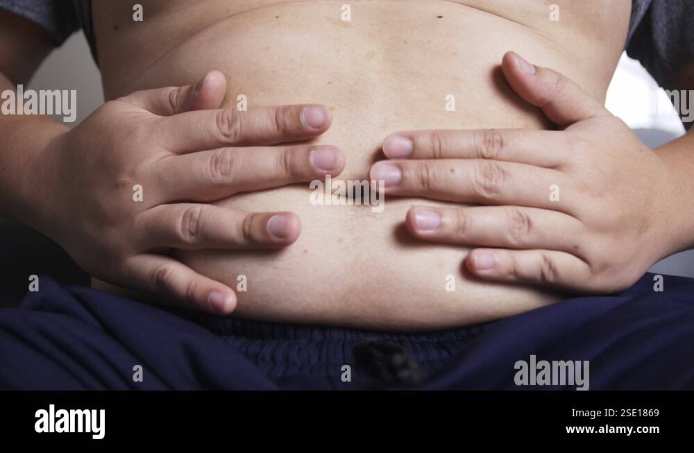 Man is pressing his hand on his stomach due to persistent abdominal ...