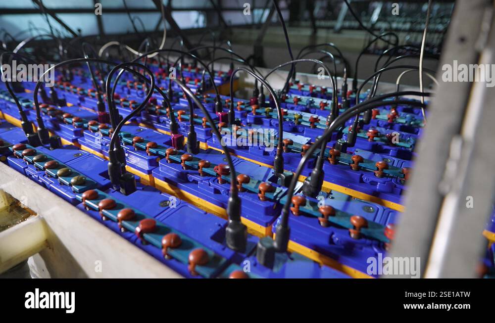 A stand for charging new batteries at the factory. Car batteries are ...