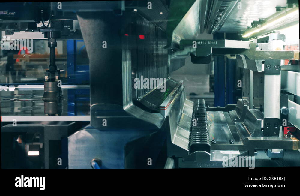 Side view of an industrial machine shearing and bending metal Stock ...