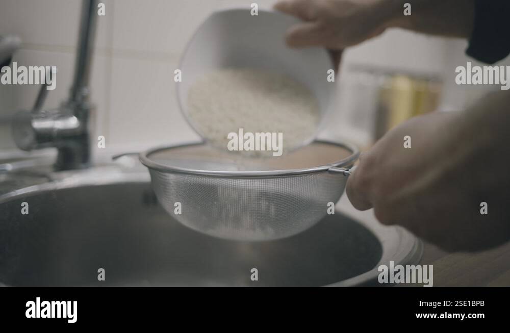 Chef pouring rice in a sieve Stock Video Footage - Alamy