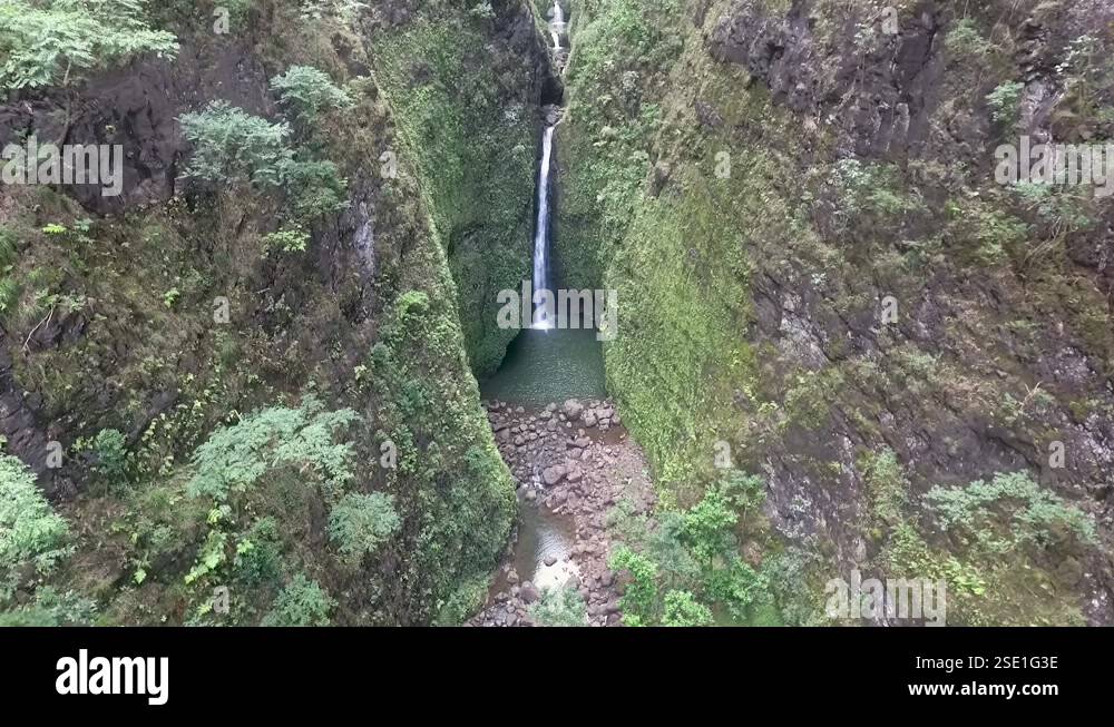 Aerial Drone shot from above Sacred Falls waterfall in middle of jungle ...
