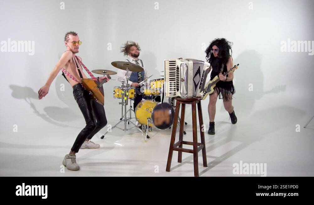 Punk rock band. Shooting a clip. Musicians are jumping with instruments ...