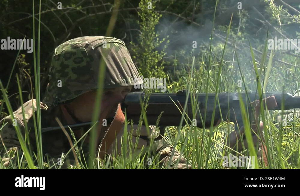 WW2 German Soldier fire MP40 machine gun in combat from a foxhole - Slo ...