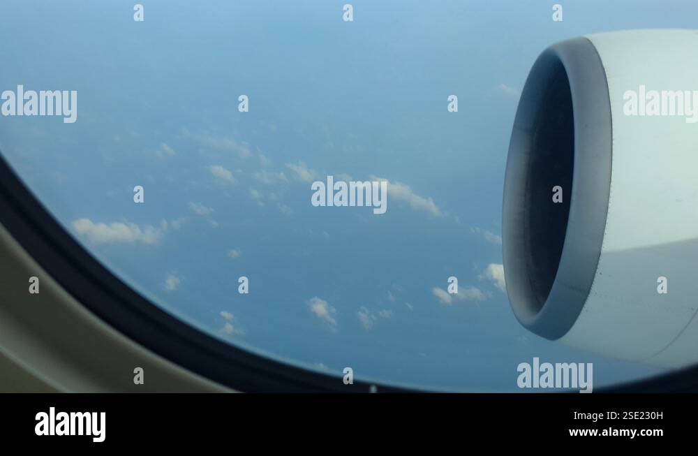 Airplane flying high mid air. View through window showing engine Stock ...