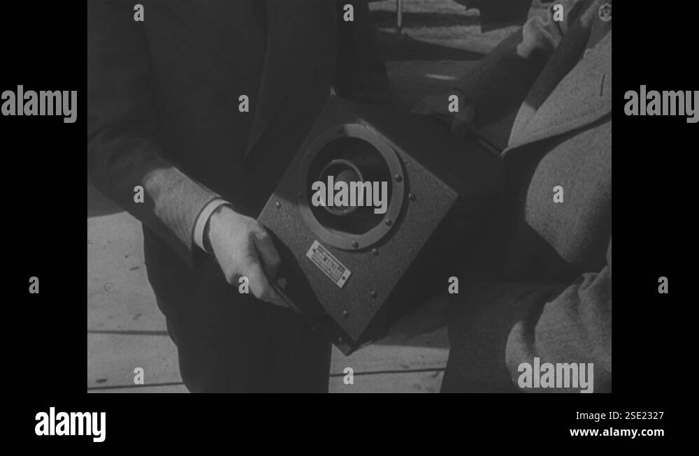 1940s: Aerial camera is loaded into cockpit of airplane. Airplane takes ...