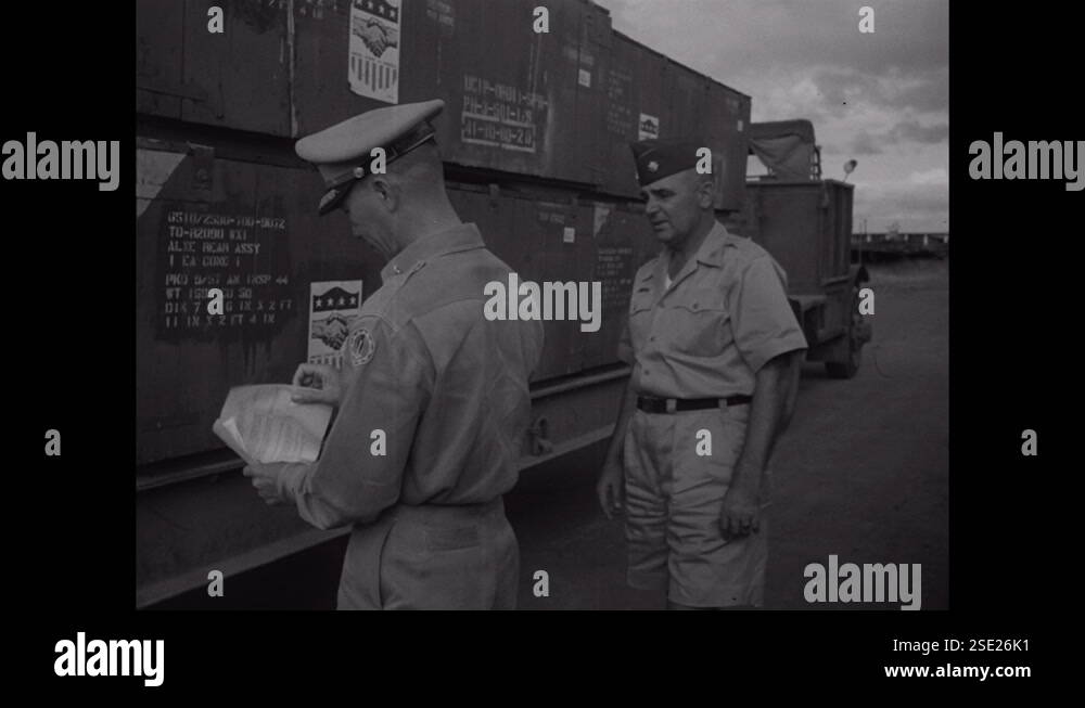 1960s: trucks carrying large load of supplies inspected by army ...