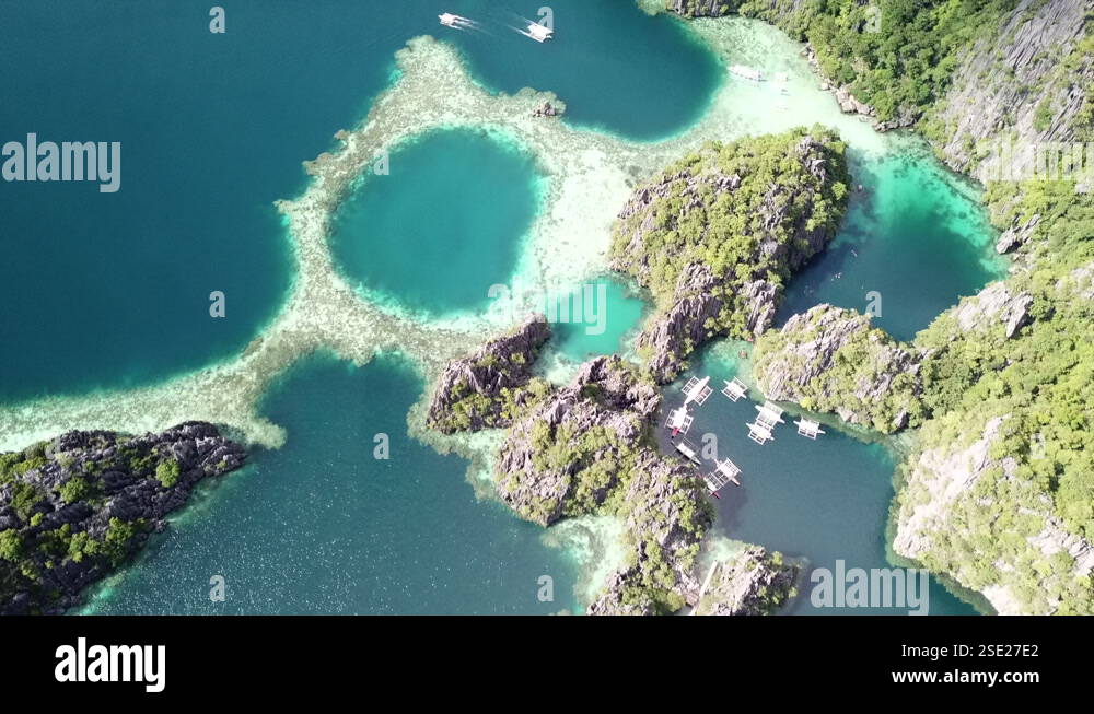Amazing cliffs of gray rocks covered by green plants with turquoise sea ...