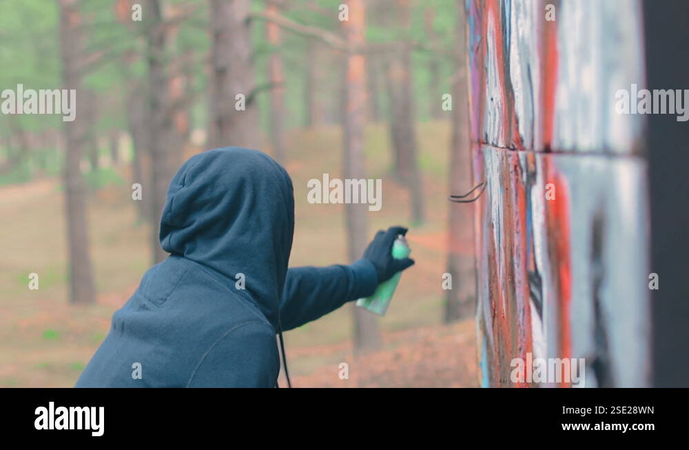 Youthful Guy Drawing Graffiti Using Spray Paint Can Stock Video Footage ...