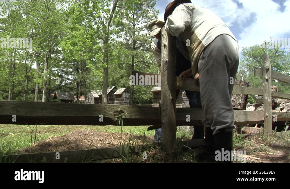 19th century Pioneer Men work at mending a wooden fence - hammer & nails Stock Video Footage - Alamy