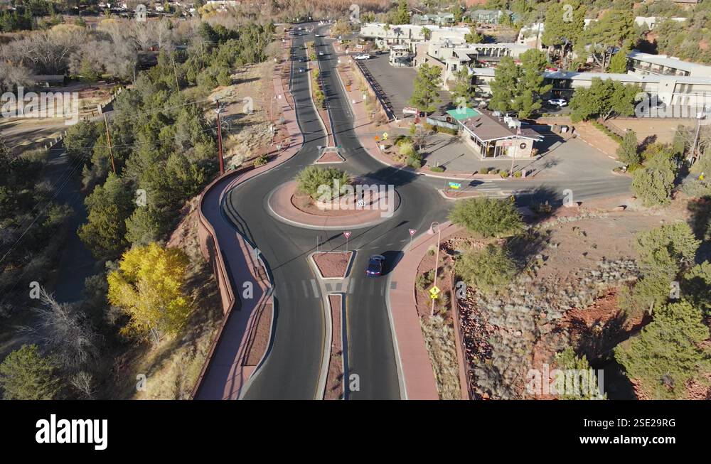 Aerial tracking shot of navy blue BMW on roundabout in Sedona, Arizona ...