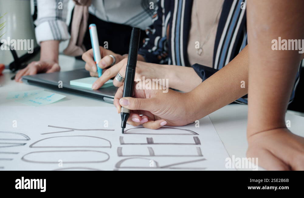Close-up slow motion of female hands drawing women empowerment posters ...