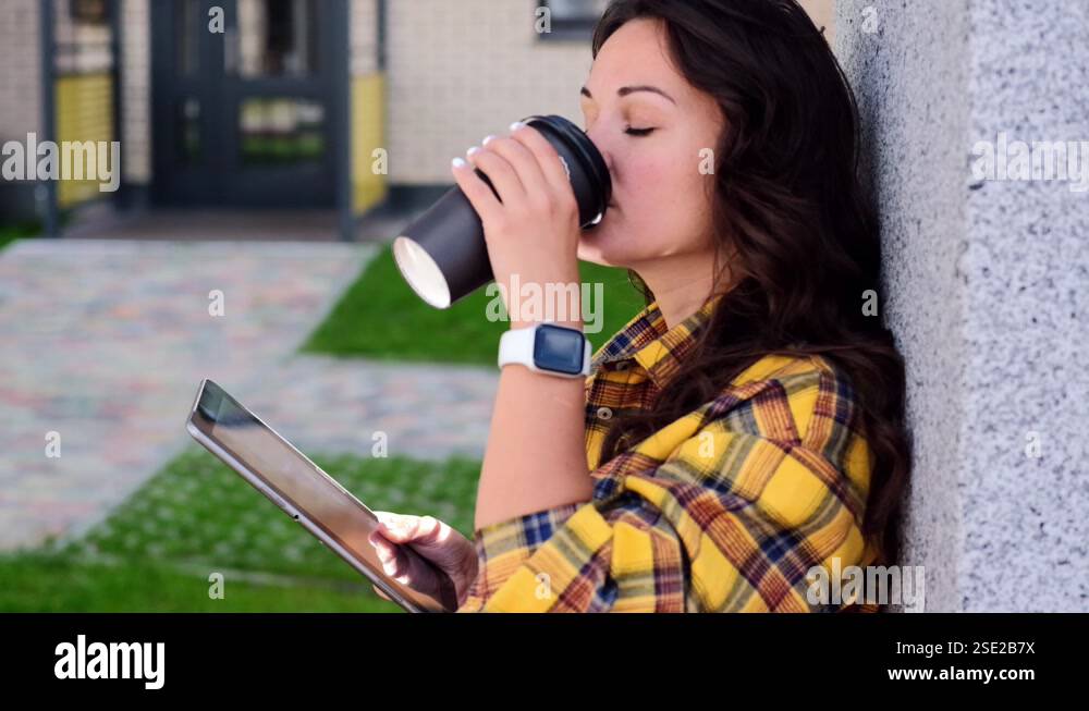 Confident business woman smiling while looking at report in tablet ...