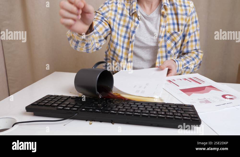 Unrecognizable man works with documents and types text on the keyboard ...