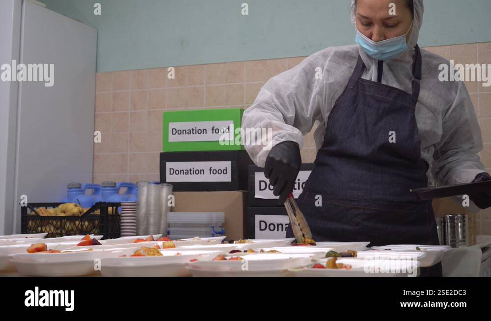 Woman volunteer, cook in mask. Food delivery. Charity project, donation ...